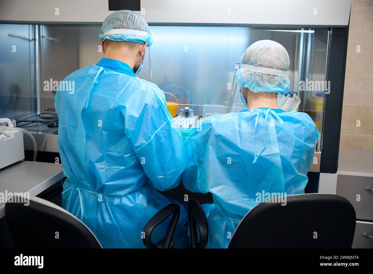 Laboratory assistants work with biomaterial with safety precautions ...