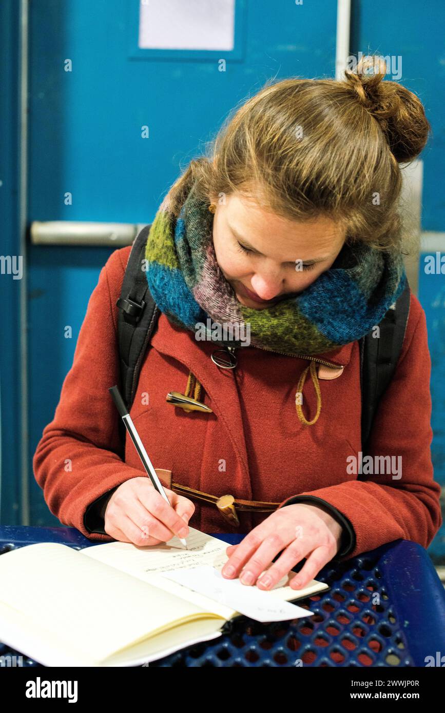 Young, female journalist making notes New York City, USA. Young adult ...