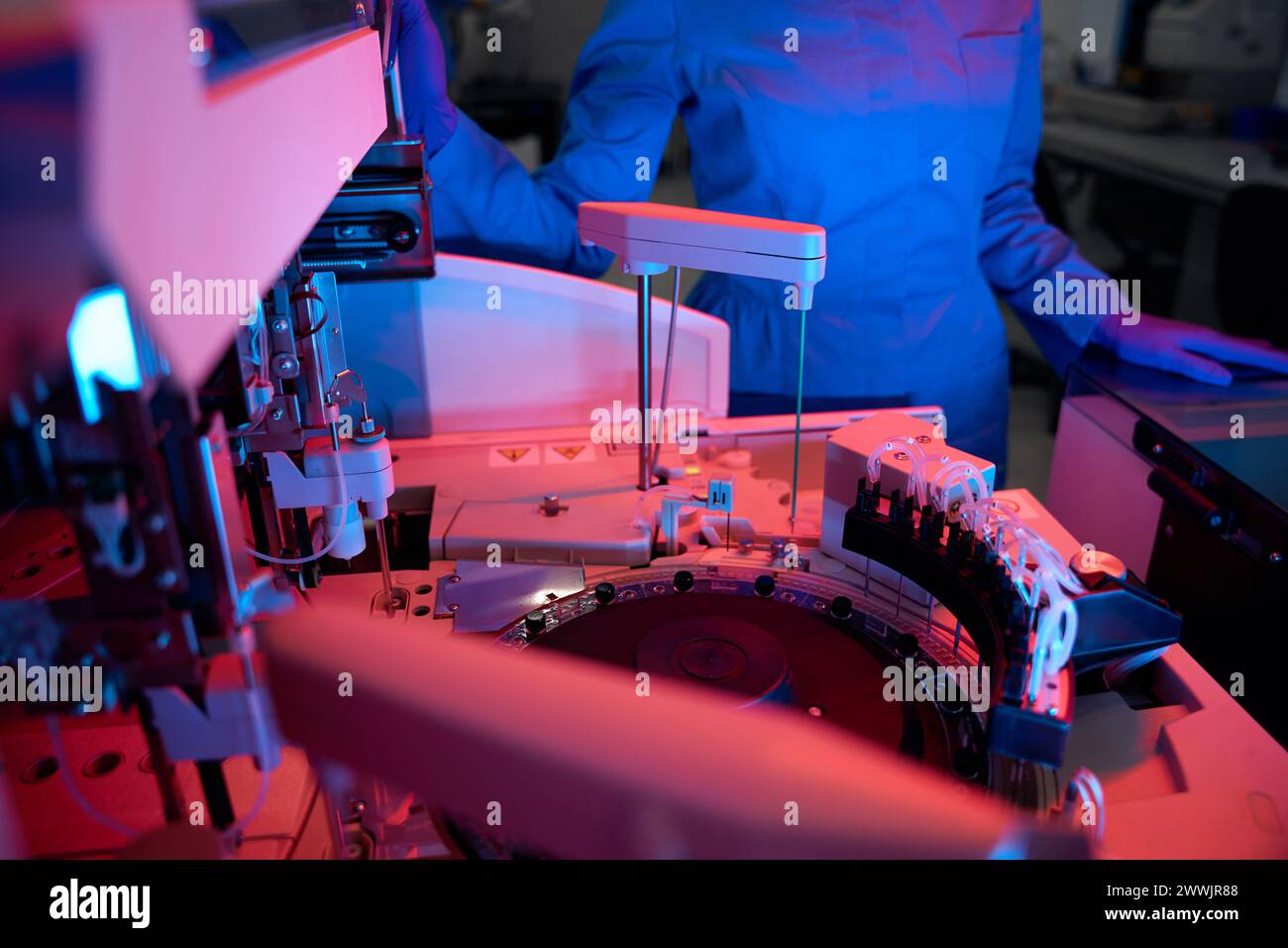 Laboratory employee uses machine for automatic isolation of nucleic ...