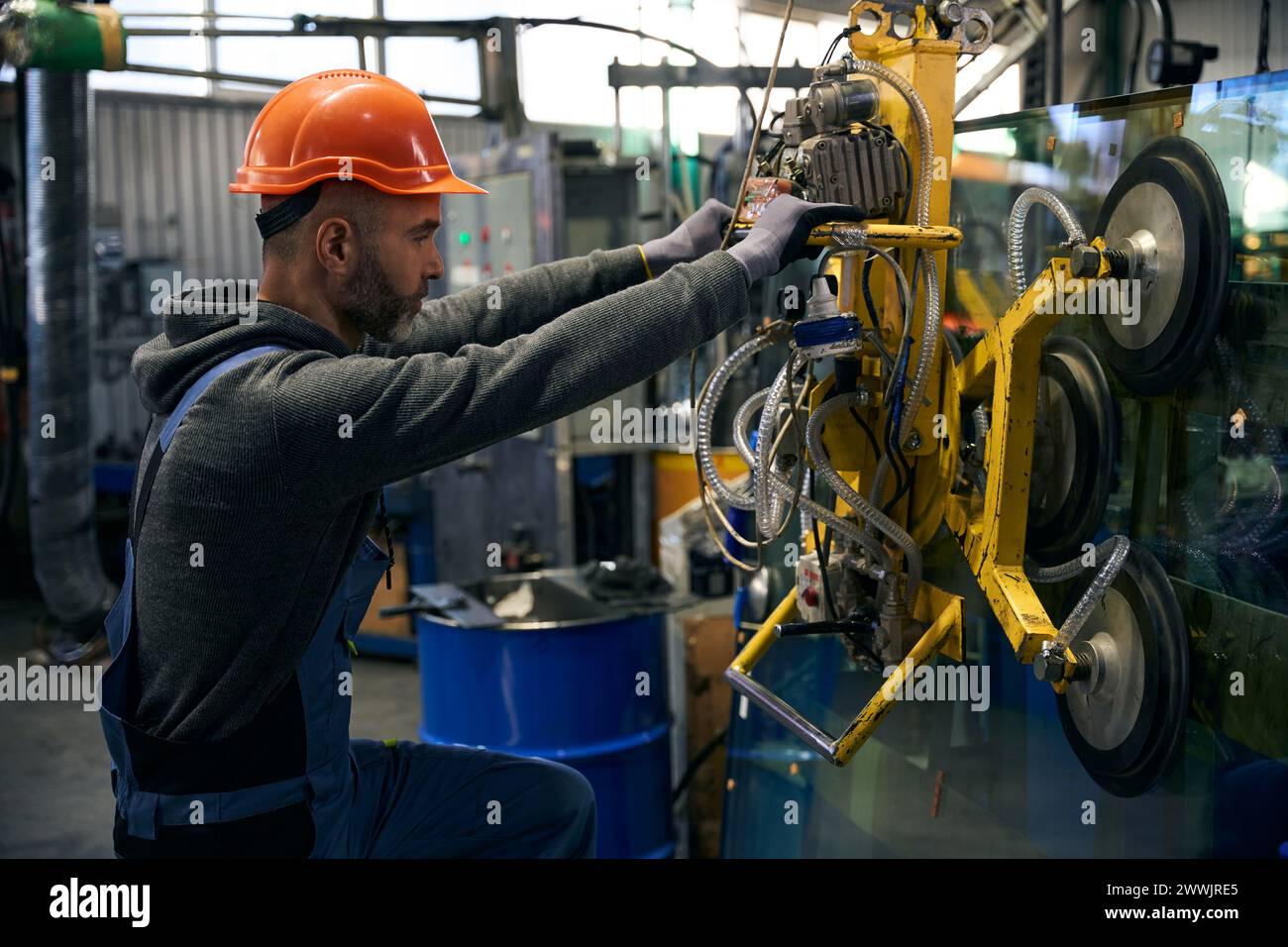 Worker works in a window production workshop Stock Photo - Alamy