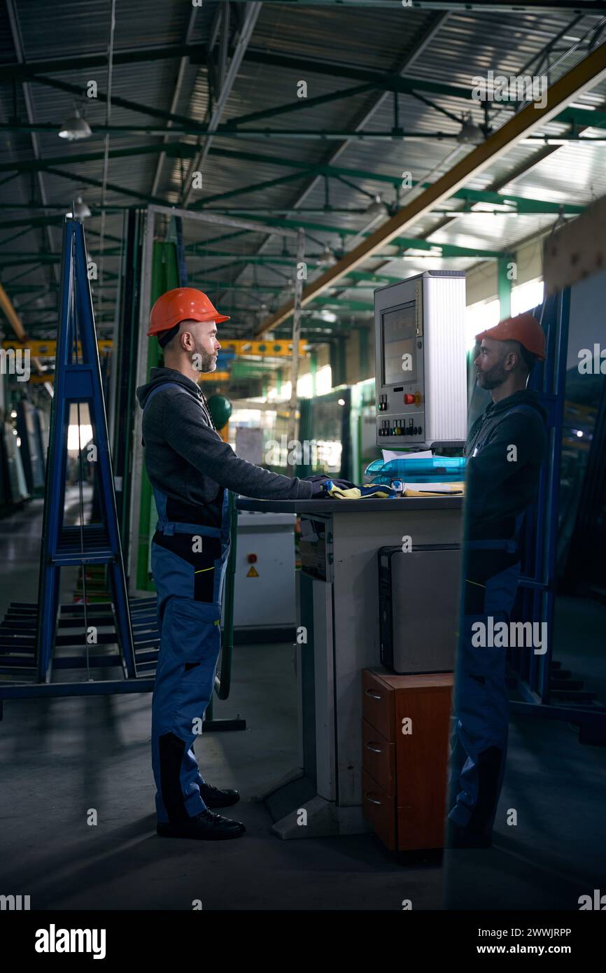 Employee uses high-tech equipment for the production of double-glazed ...