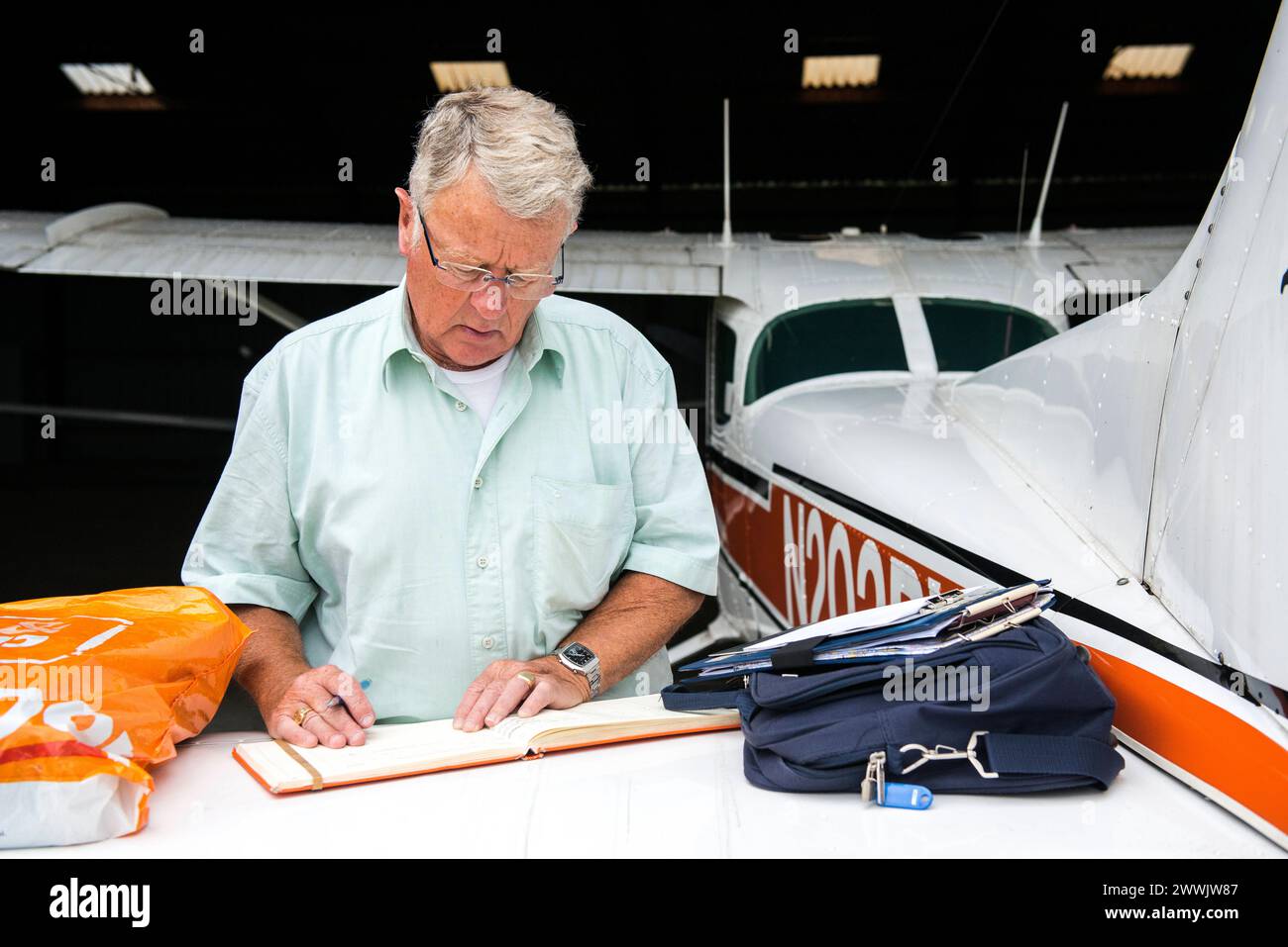 Pilot filing log Seppe Airport, Netherlands. Small Cesna Pilot working ...