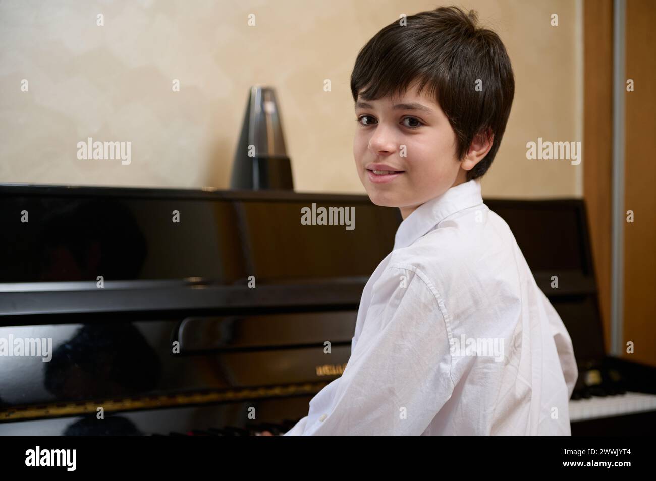 Close-up portrait multi ethnic teen boy, little pianist musician ...