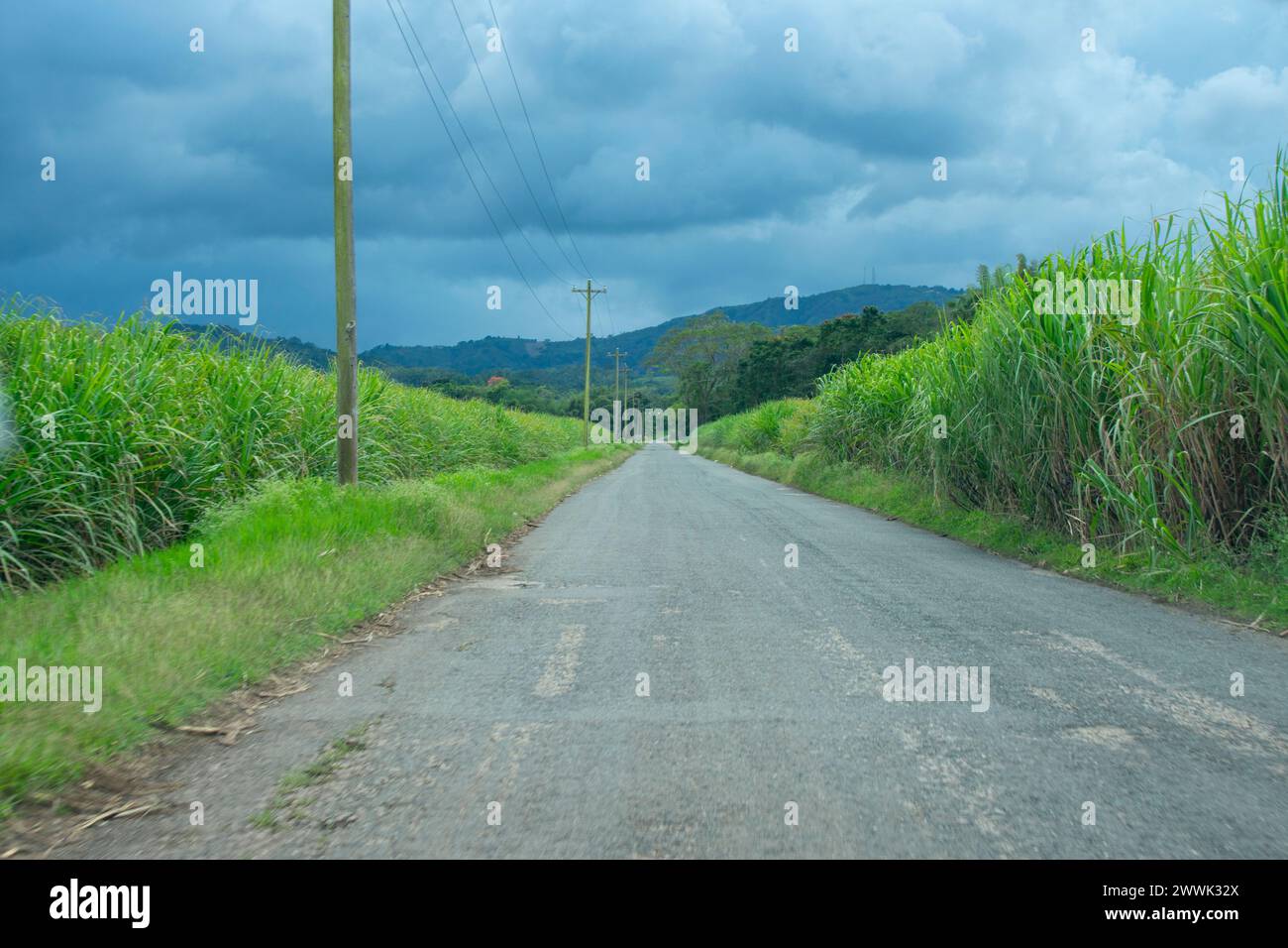 Clear open country road leading to the vanishing point and mountains in ...