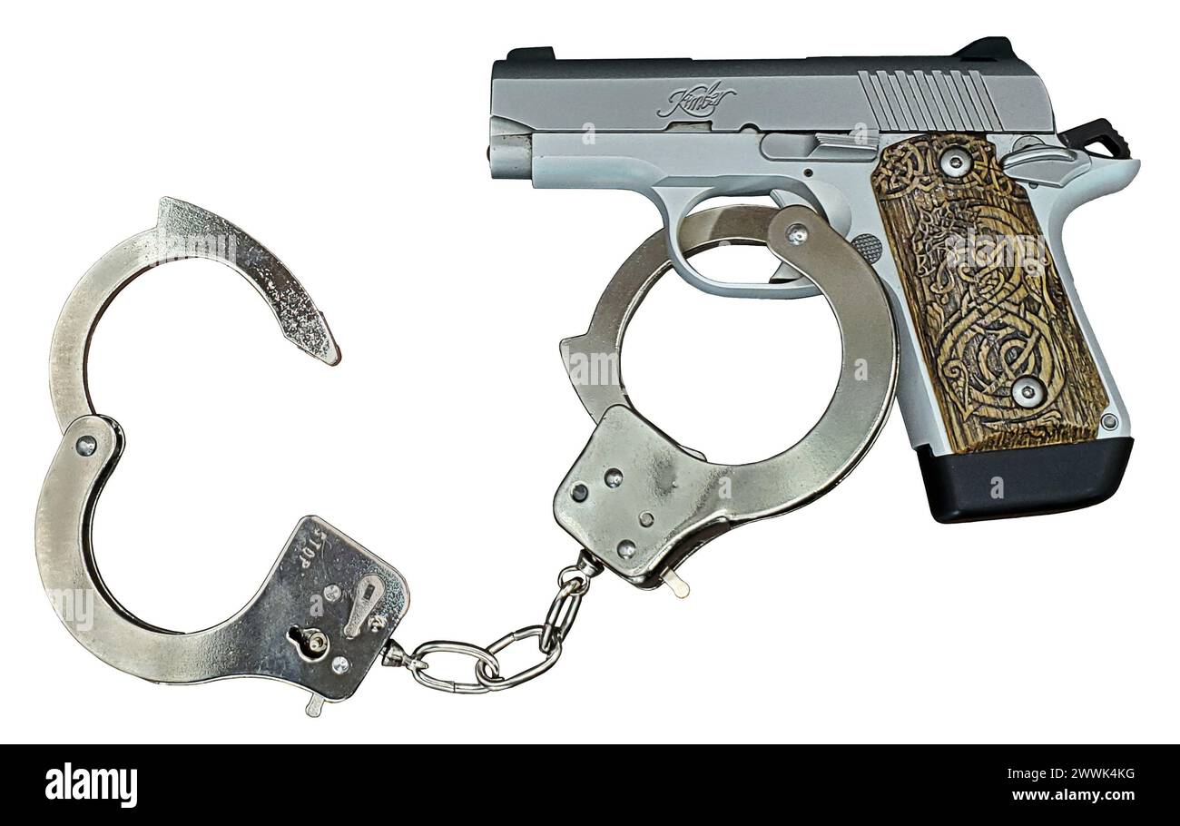 Silver metal gun with Celtic Engraved grip with handcuffs on the ...