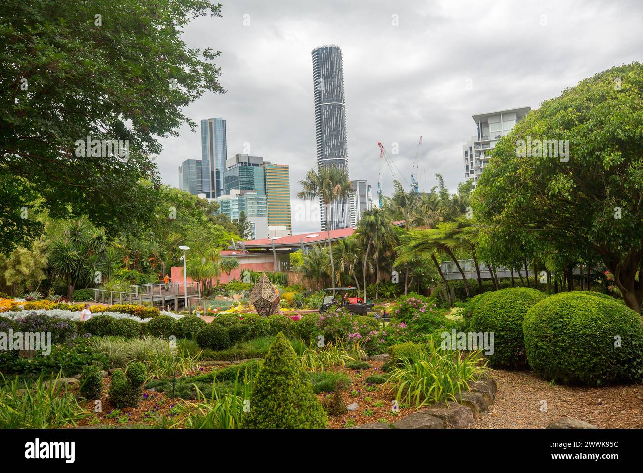 Skyscrapers and buildings of city CBD rising into sky beyond lush ...