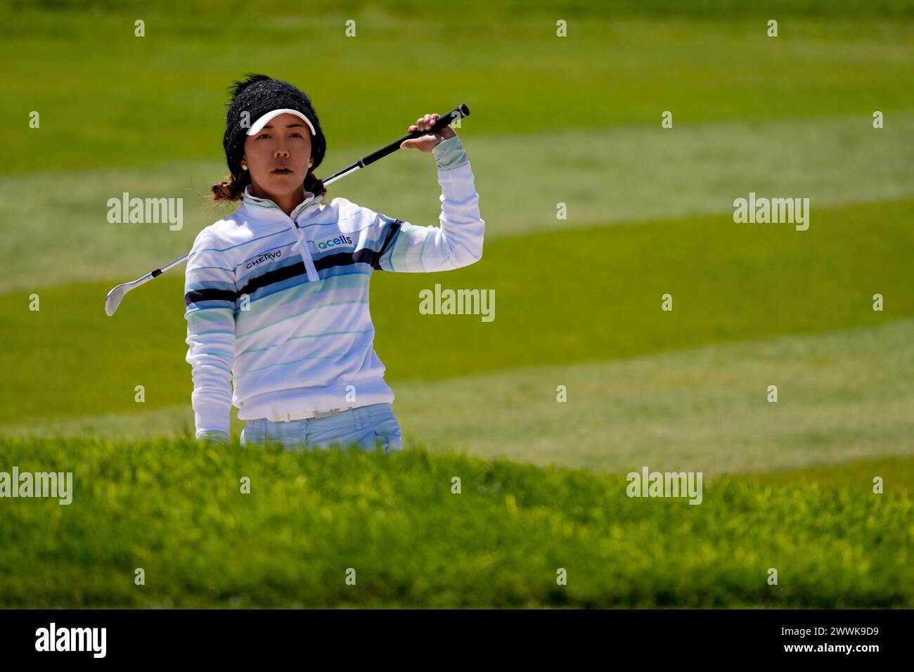Jenny Shin, of South Korea, reacts after her bunker shot toward the ...