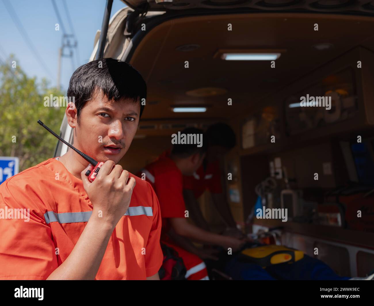 Portrait of an emergency care worker standing in front of an ambulance ...