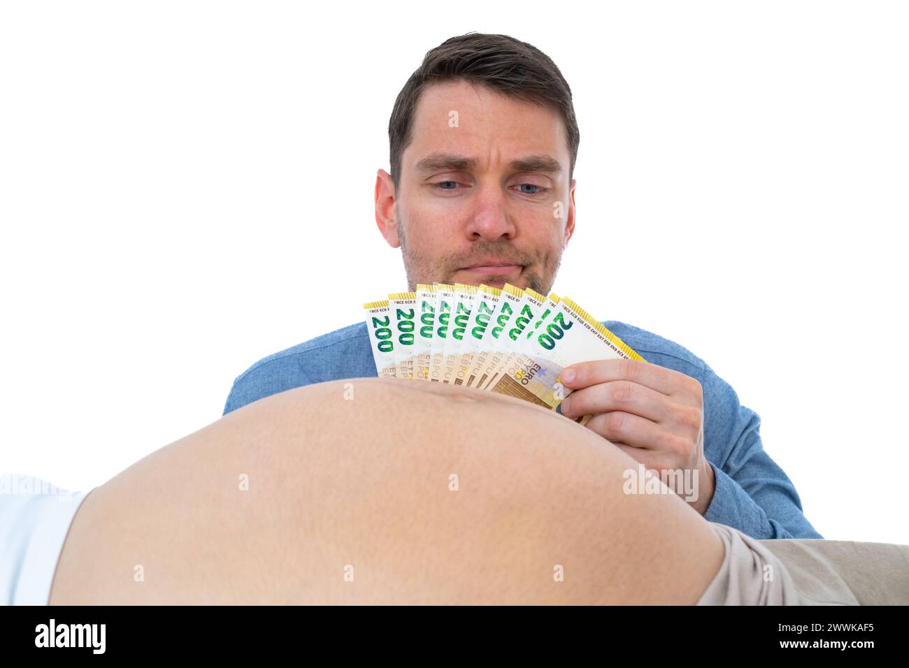 Description: Expectant father is sceptically pulling out banknotes of ...