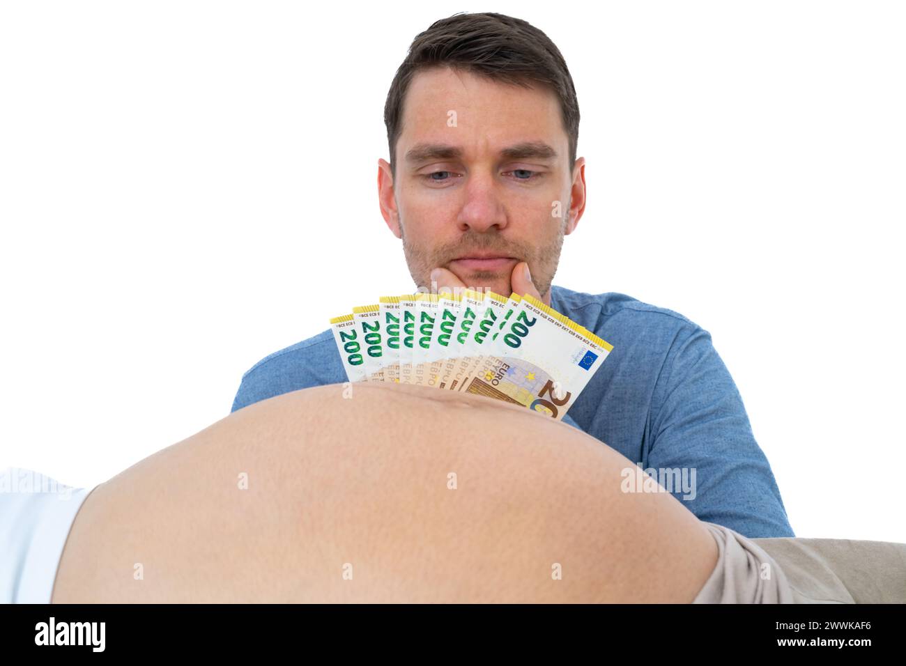 Description: Expectant father with banknotes in his hands looks ...
