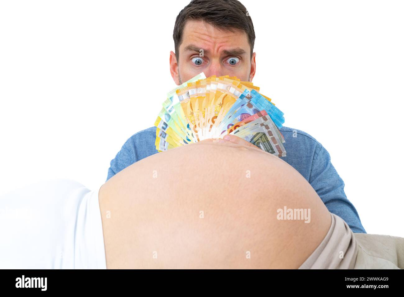 Description: Expectant father looks anxiously at a stack of banknotes ...
