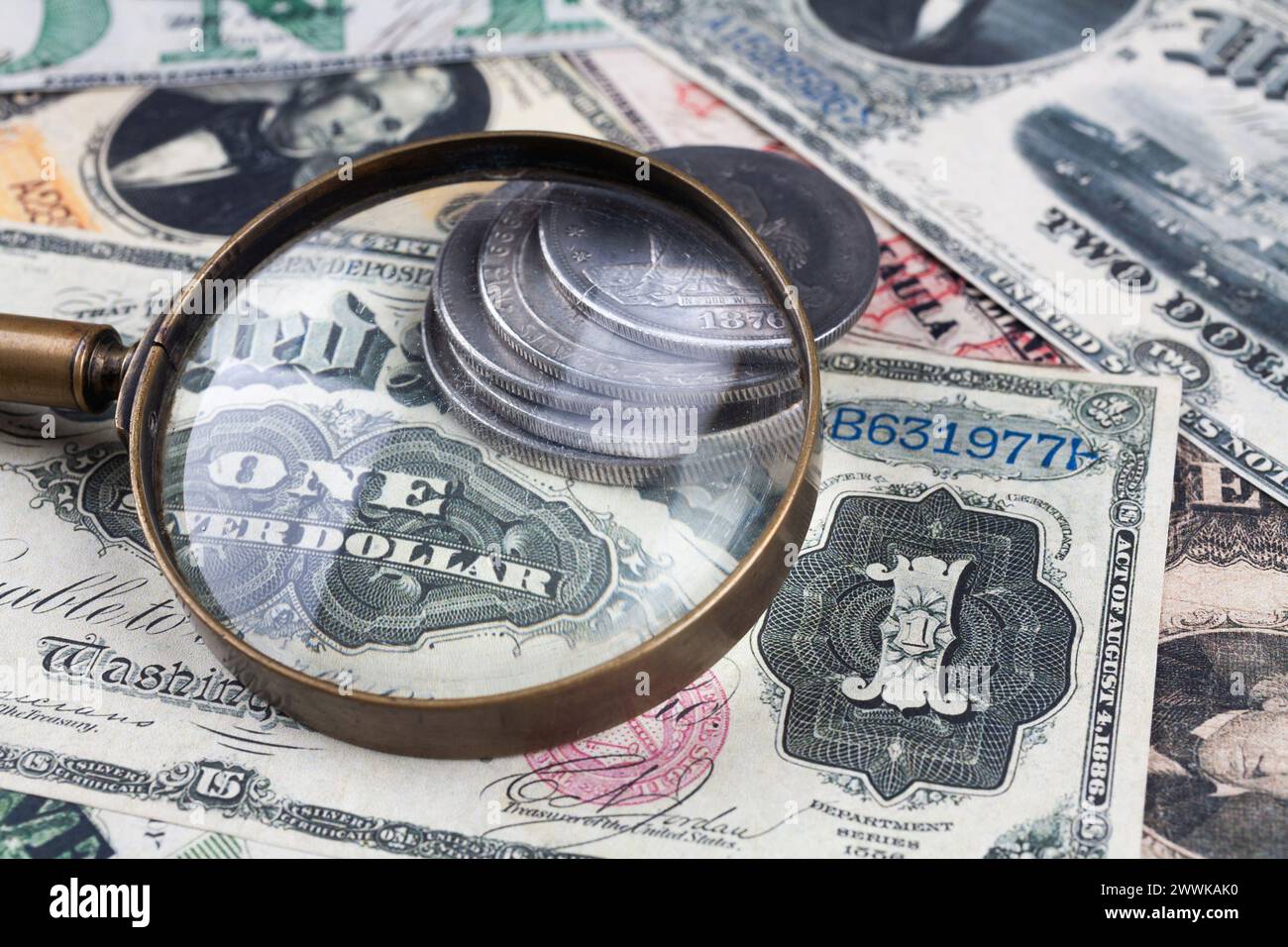 Old US banknotes and silver certificates with silver dollar coins and ...