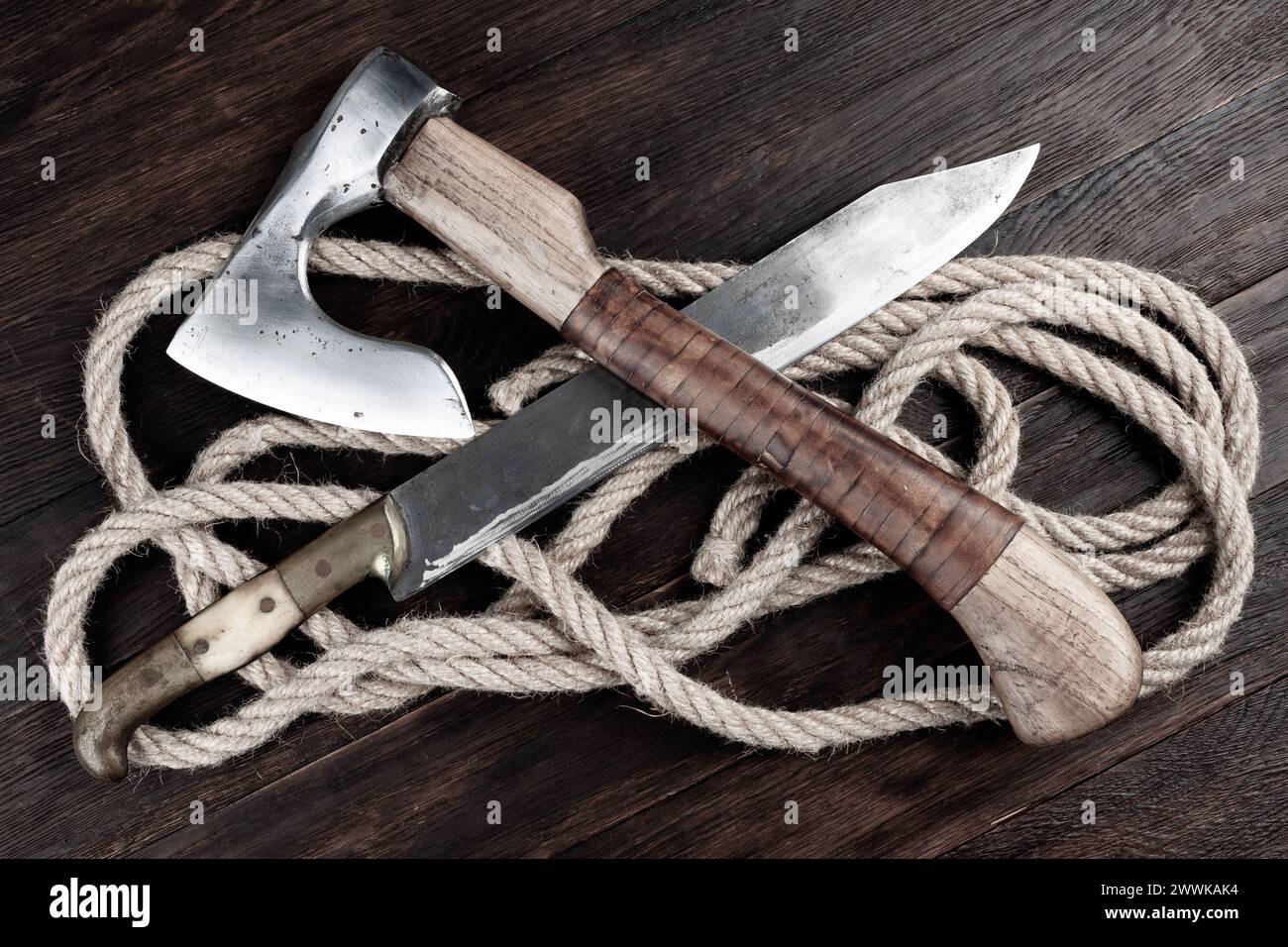 small axe with bowie knife and rope on wooden background Stock Photo ...