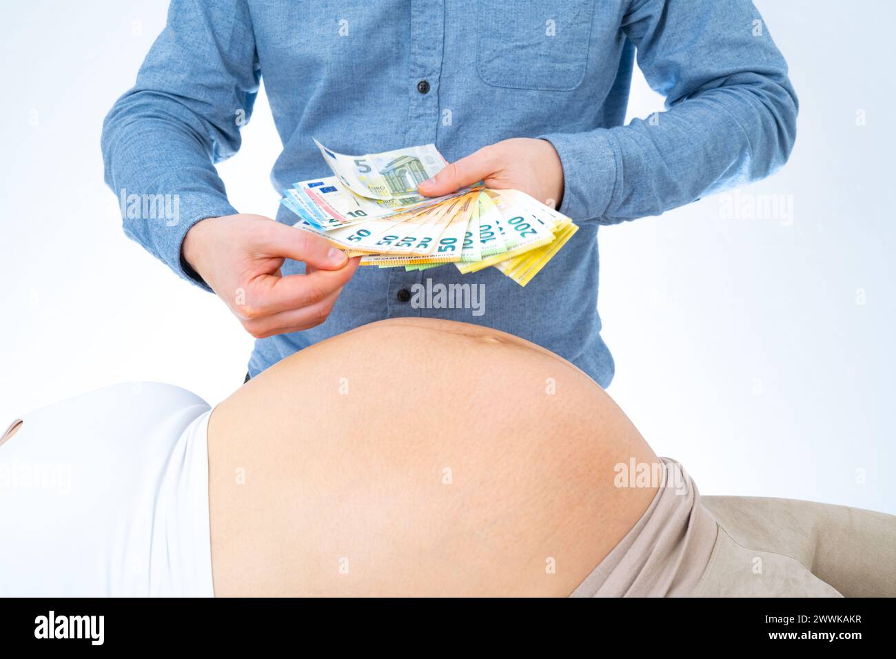 Description: Unrecognizable father holds stack of banknotes over ...