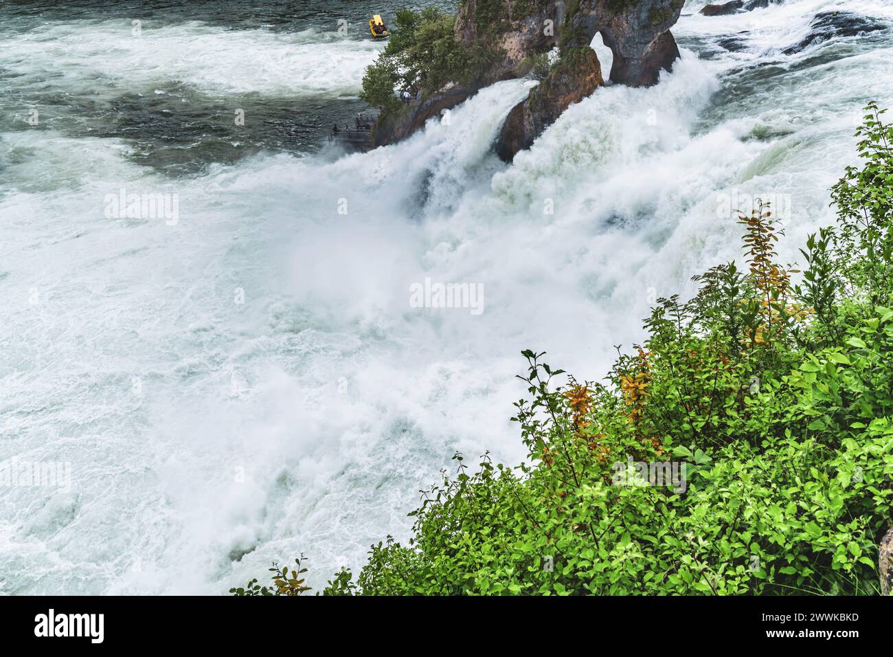 Description: Tourists watch the massive waterfalls below Laufen Castle at the Rhine Falls from ...