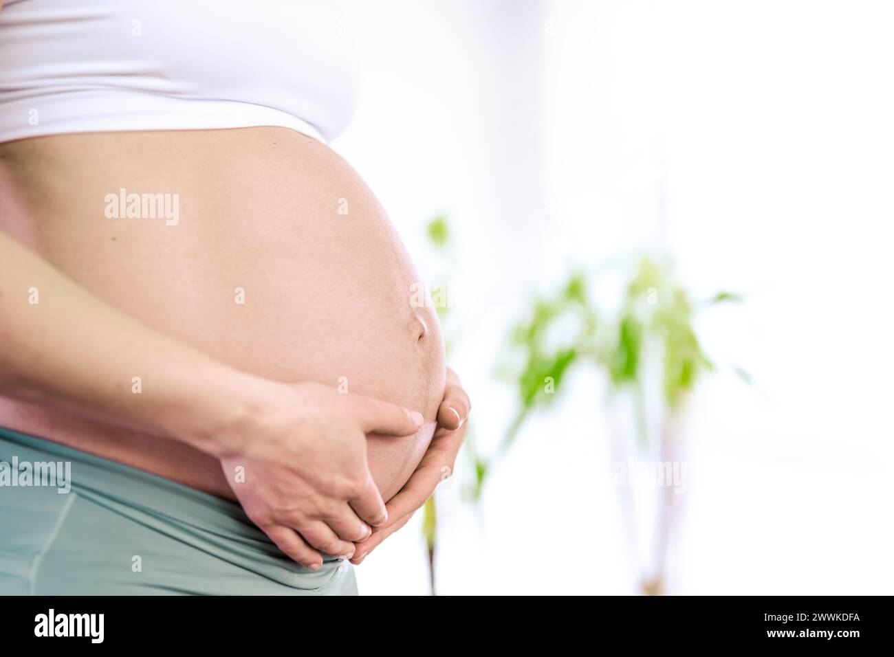 Description: Lateral view of midsection of unrecognizable woman gently ...