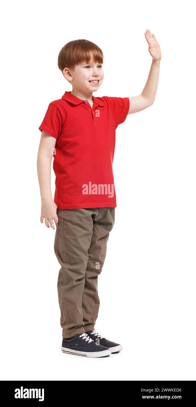 Smiling little boy waving hand on white background Stock Photo - Alamy