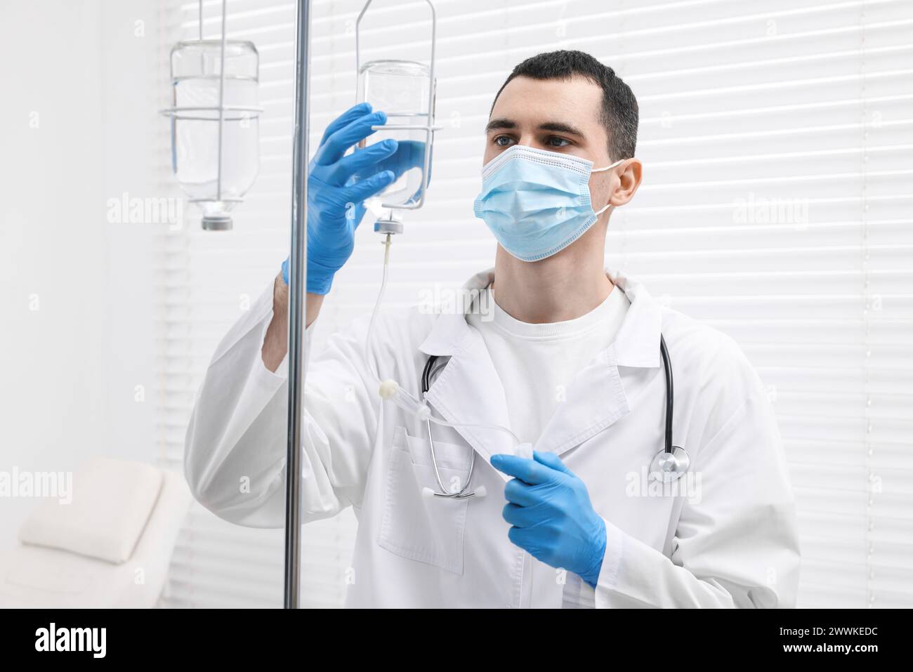 Doctor setting up IV drip in hospital Stock Photo - Alamy