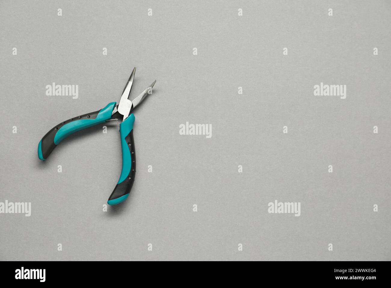 Bent nose pliers on grey background, top view. Space for text Stock ...