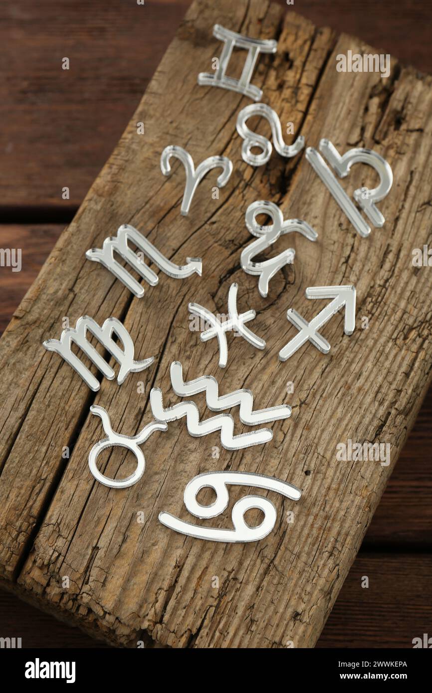 Zodiac signs on wooden table, above view Stock Photo - Alamy