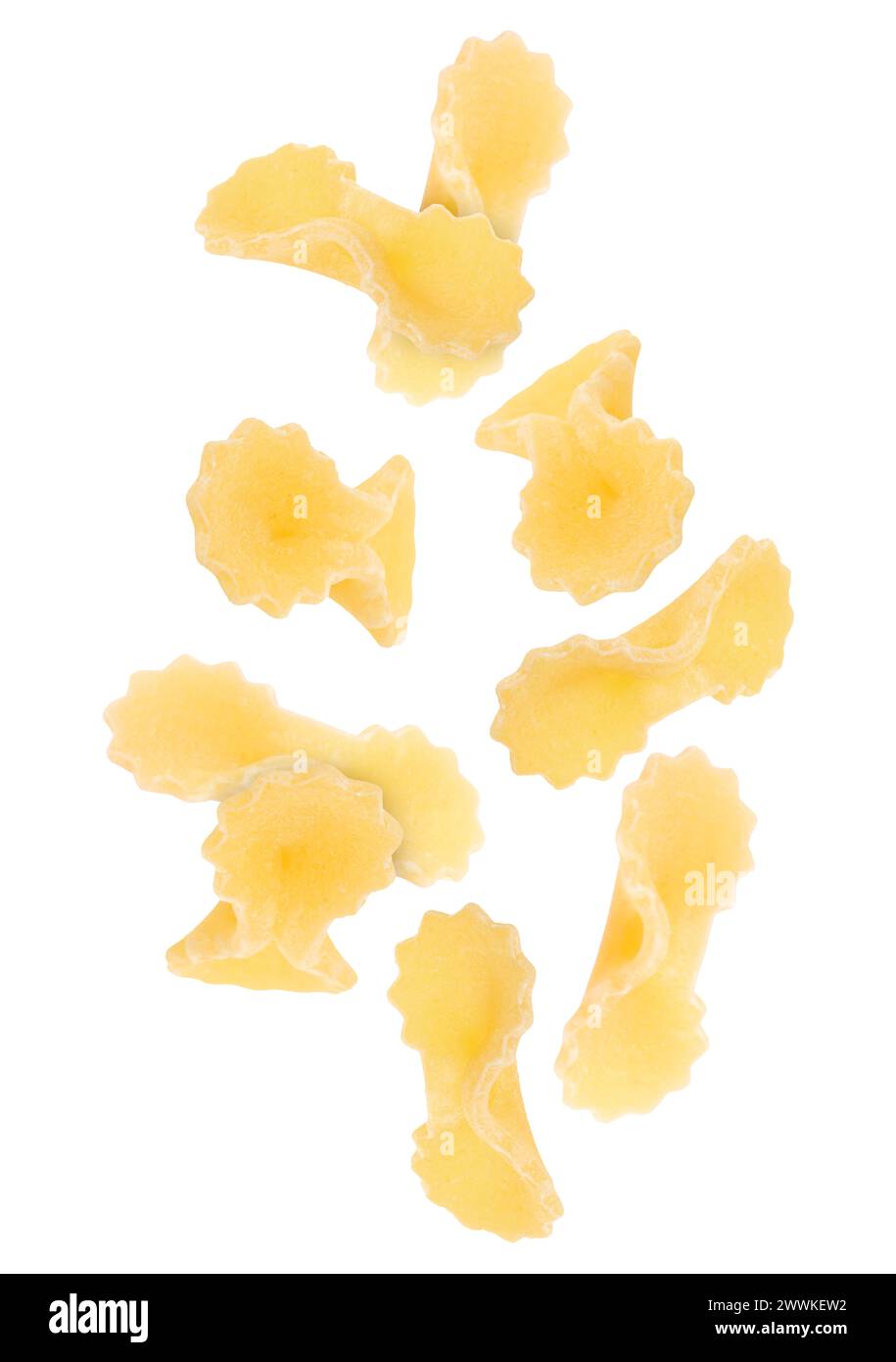 Raw farfalline pasta falling on white background Stock Photo - Alamy