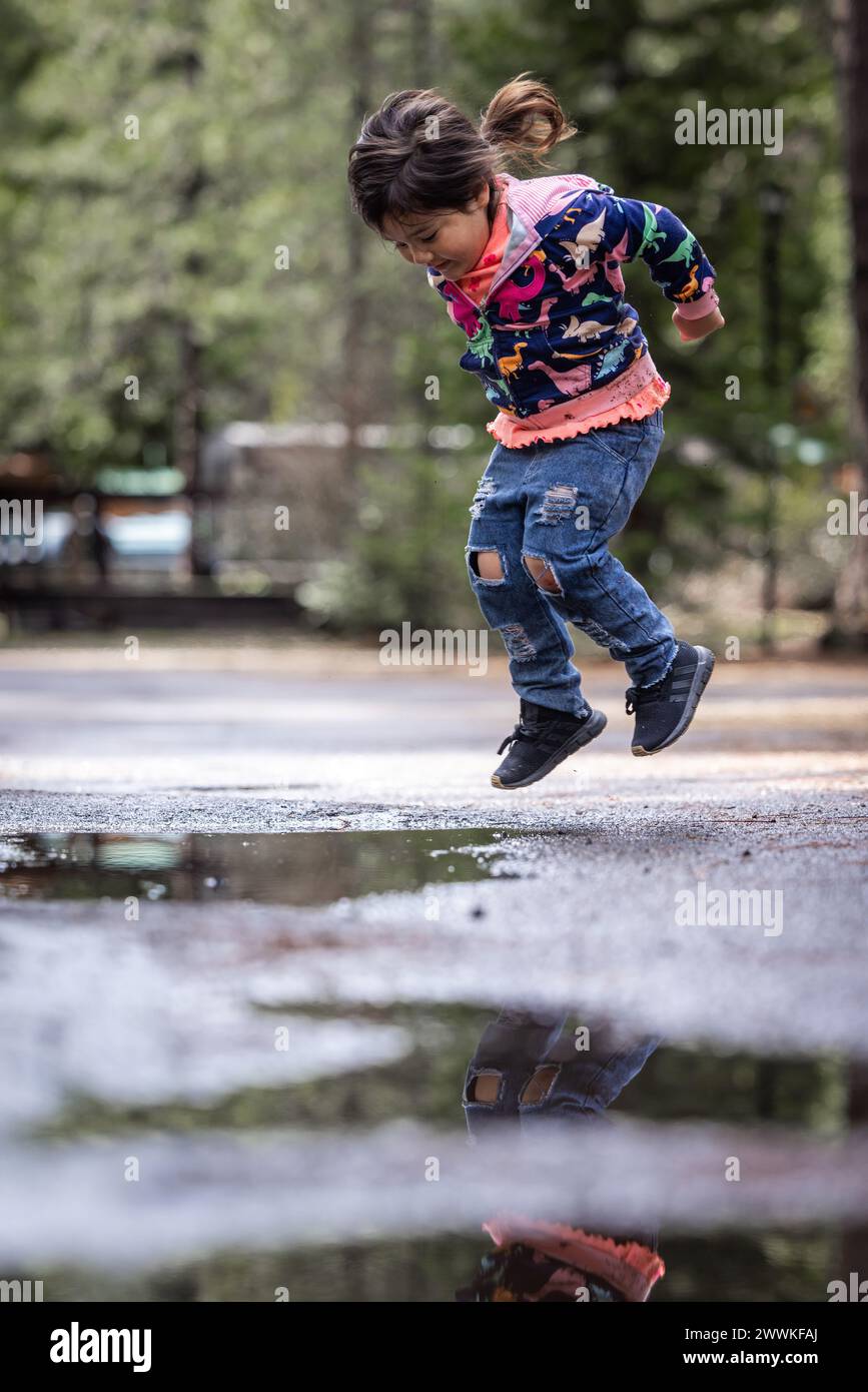 Kid jumping in a mud puddle hi-res stock photography and images - Alamy