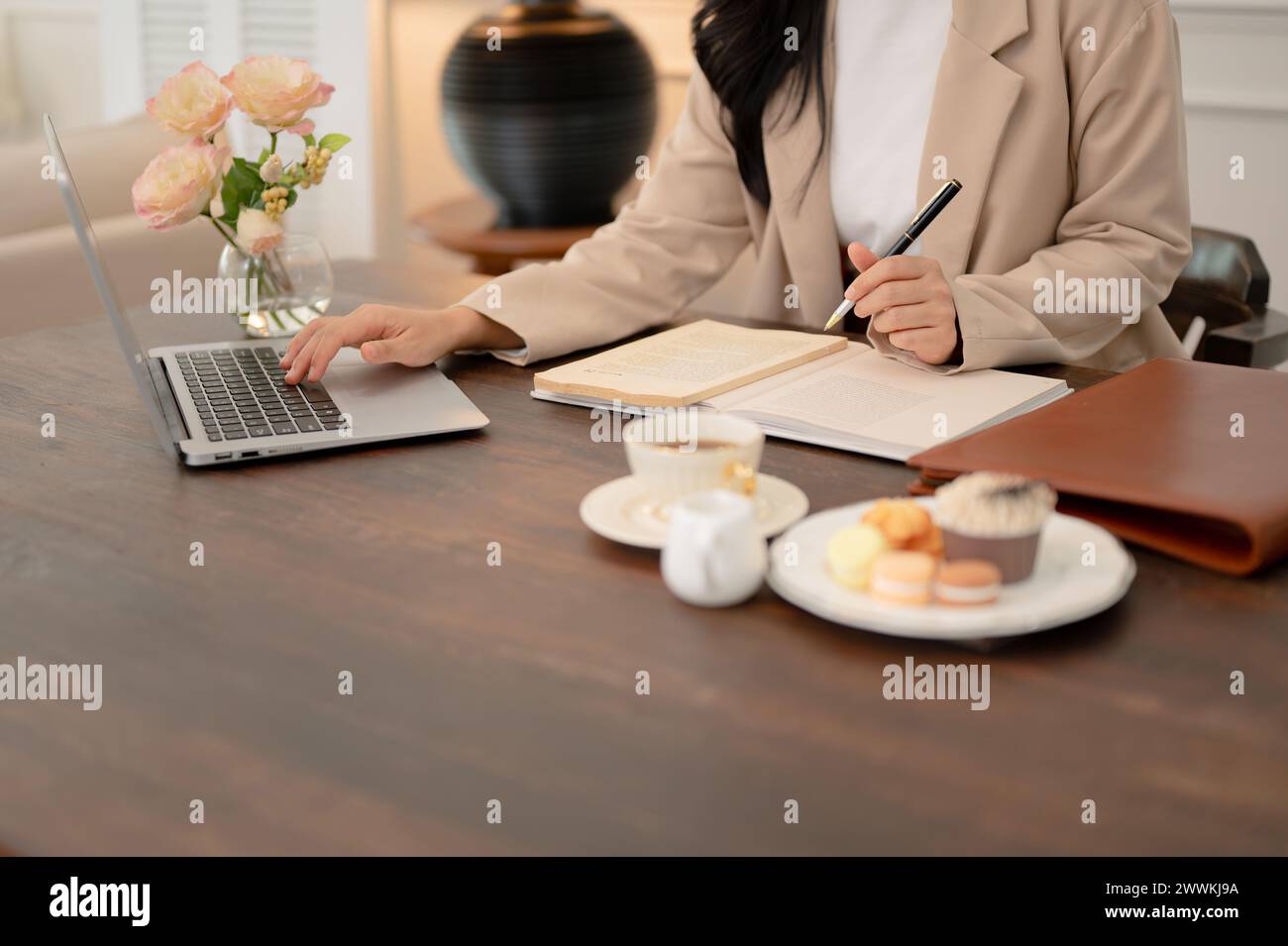 A close-up shot of a businesswoman working in her beautiful, aesthetic ...