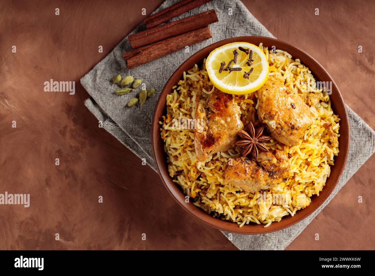 Indian Chicken Biryani with Aromatic Spices in Bowl on Brown Background ...