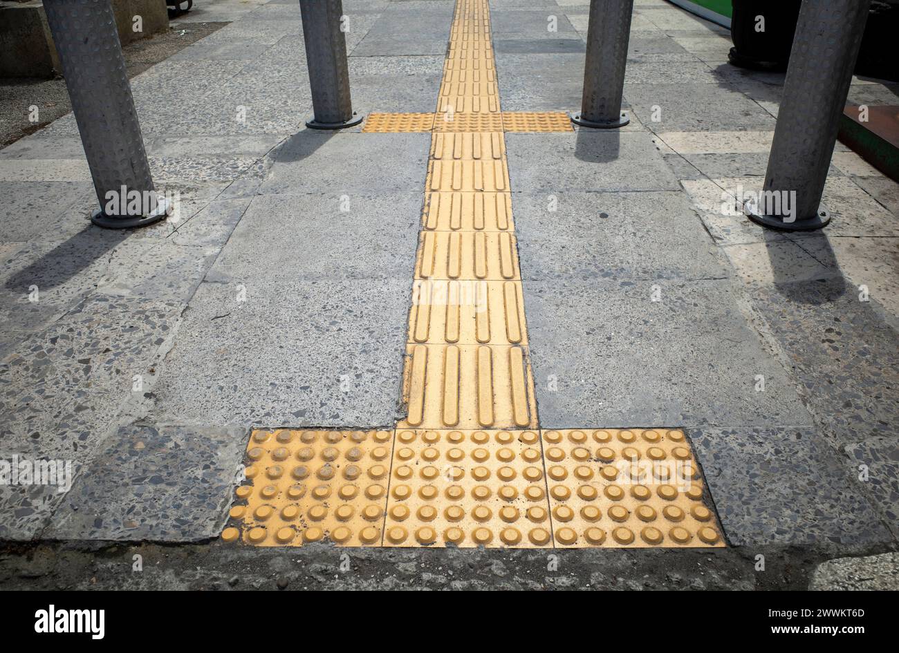 Yellow tactile paving for blind people or visually impaired on the ...