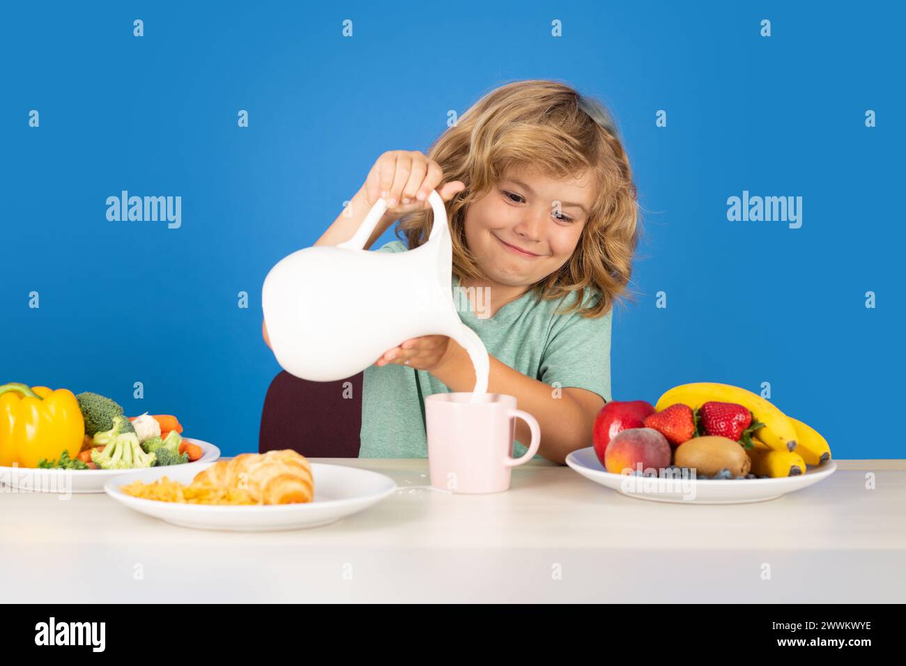 Child drink dairy milk. Kid pours dairy milk Stock Photo - Alamy