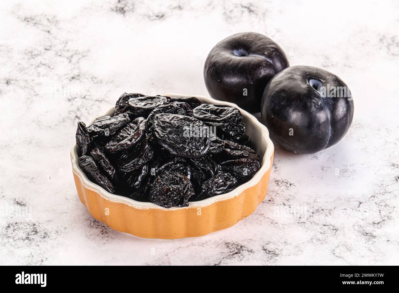 Dry sweet prunes in thw bowl Stock Photo - Alamy