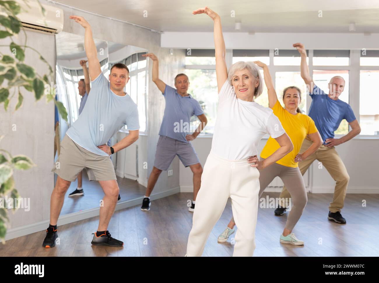 Elderly woman dances modern dances in group Stock Photo - Alamy
