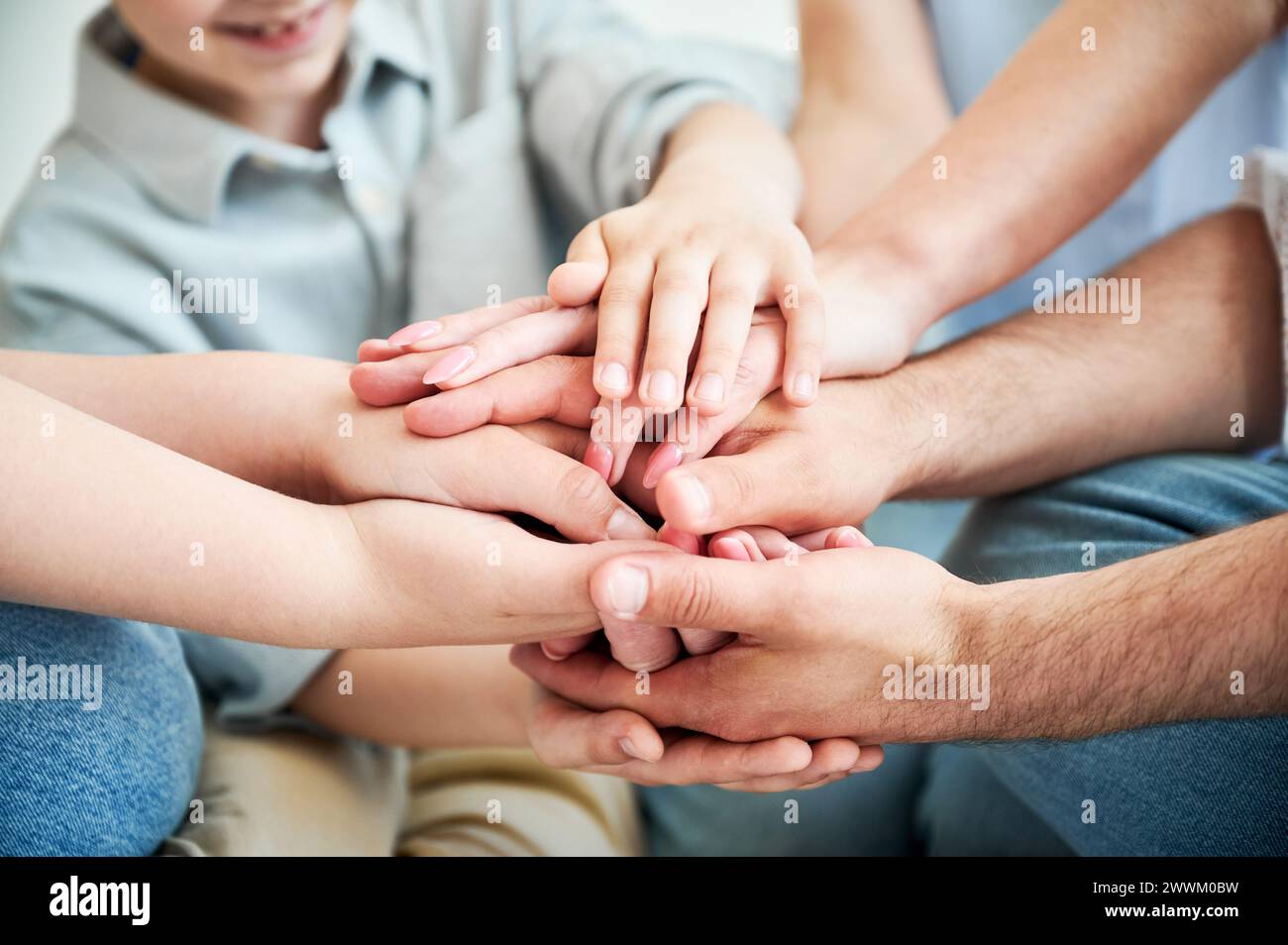 Close-up of several hands placed on top of one another in stack. Big ...