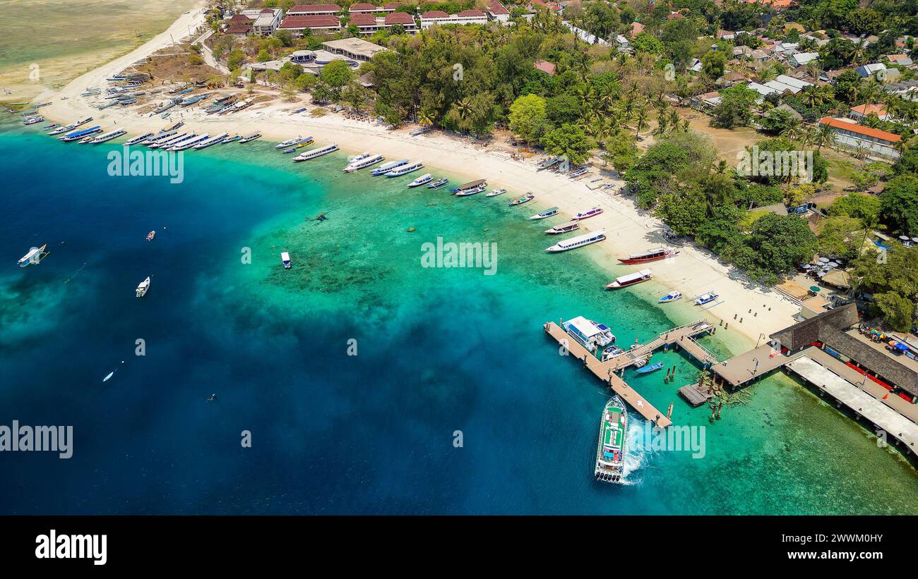 Tourist boats and ferries at the port on the small tropical island of ...