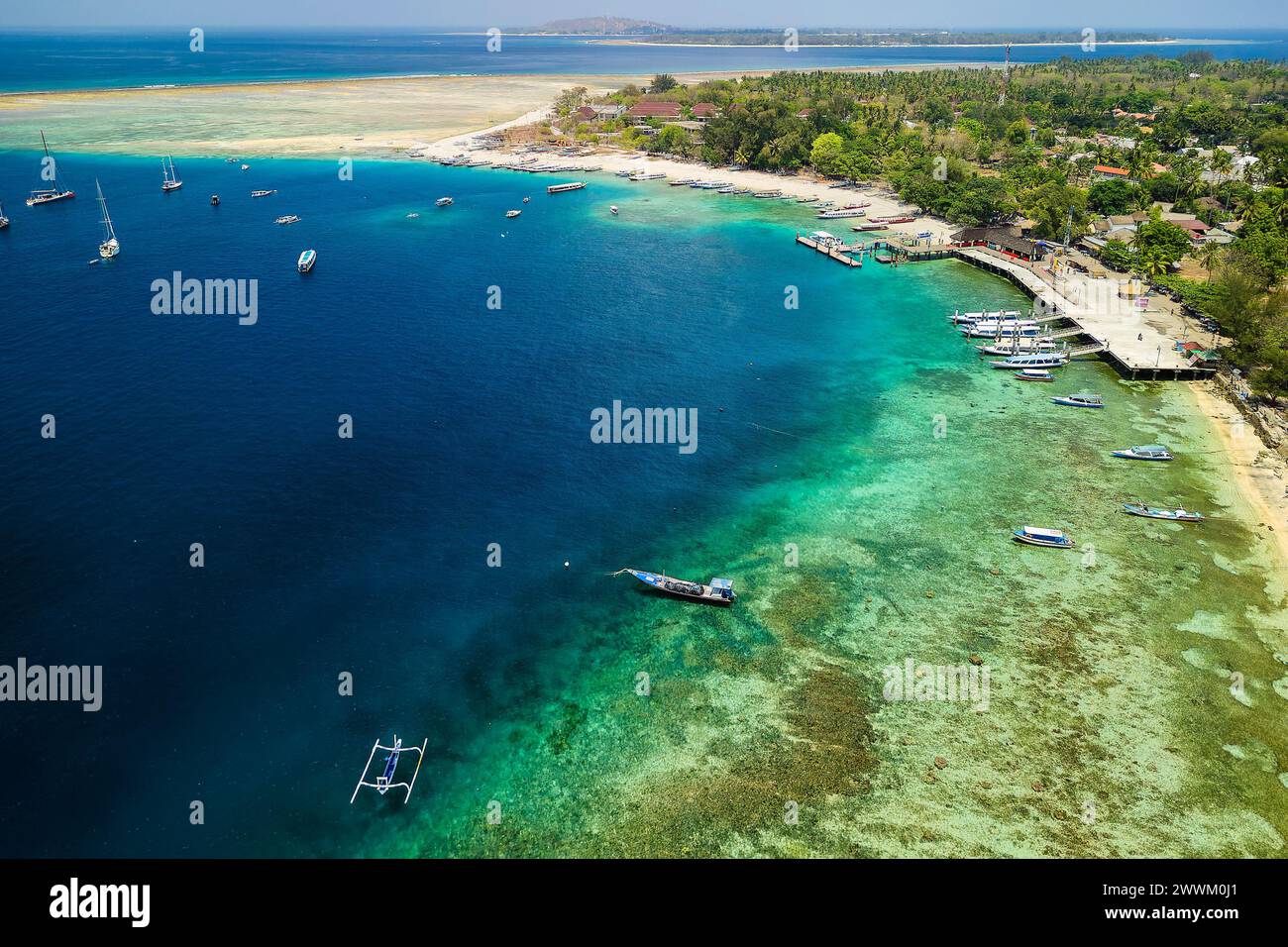 Boats surrounding a coral reef and small tropical island Stock Photo ...
