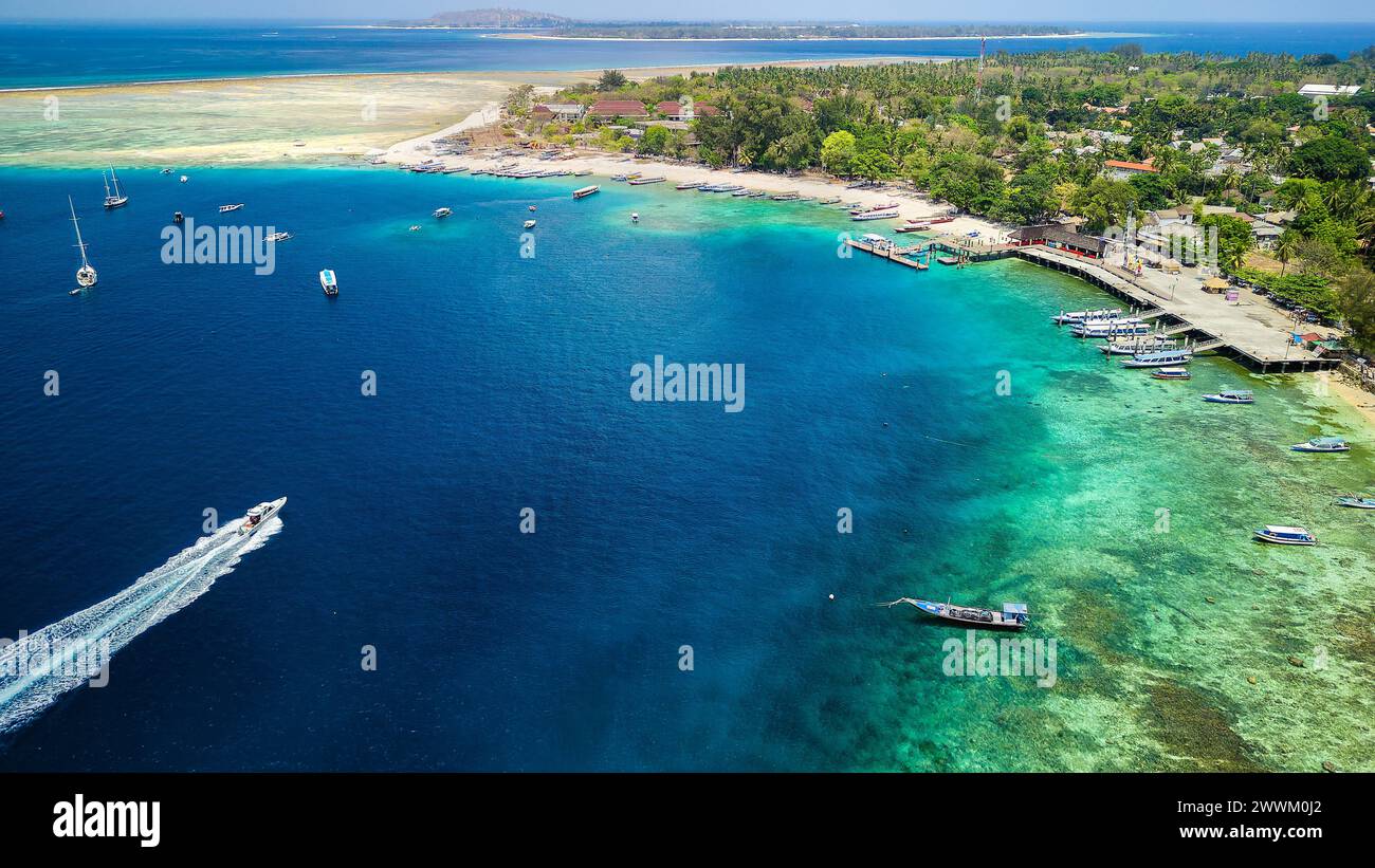 Boats surrounding a coral reef and small tropical island Stock Photo ...