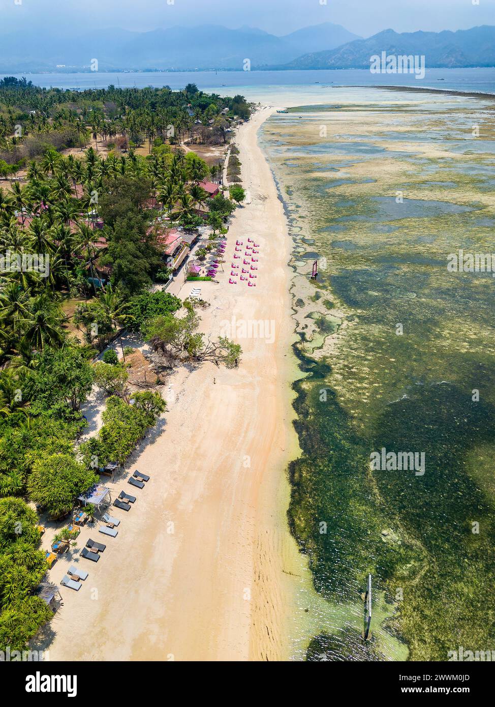 Top down aerial view of a tropical beach and resorts on a small island ...