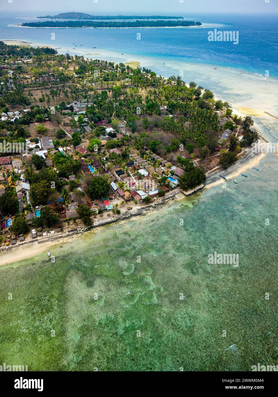 Aerial view of a fringing tropical coral reef around the coastline of a ...