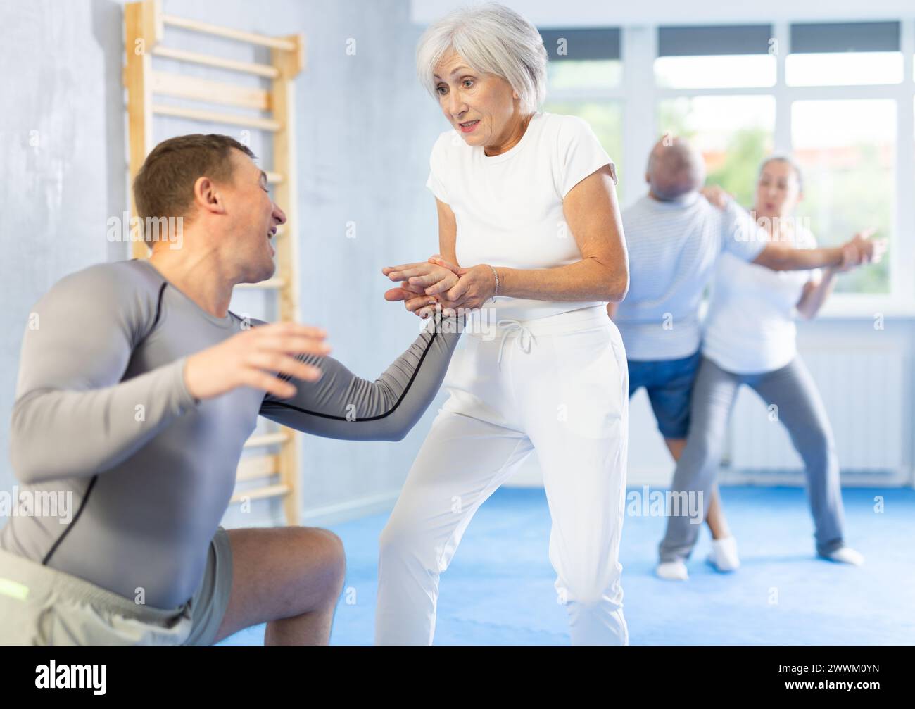 Old woman twisting her opponent's arm during self-defense classes Stock ...
