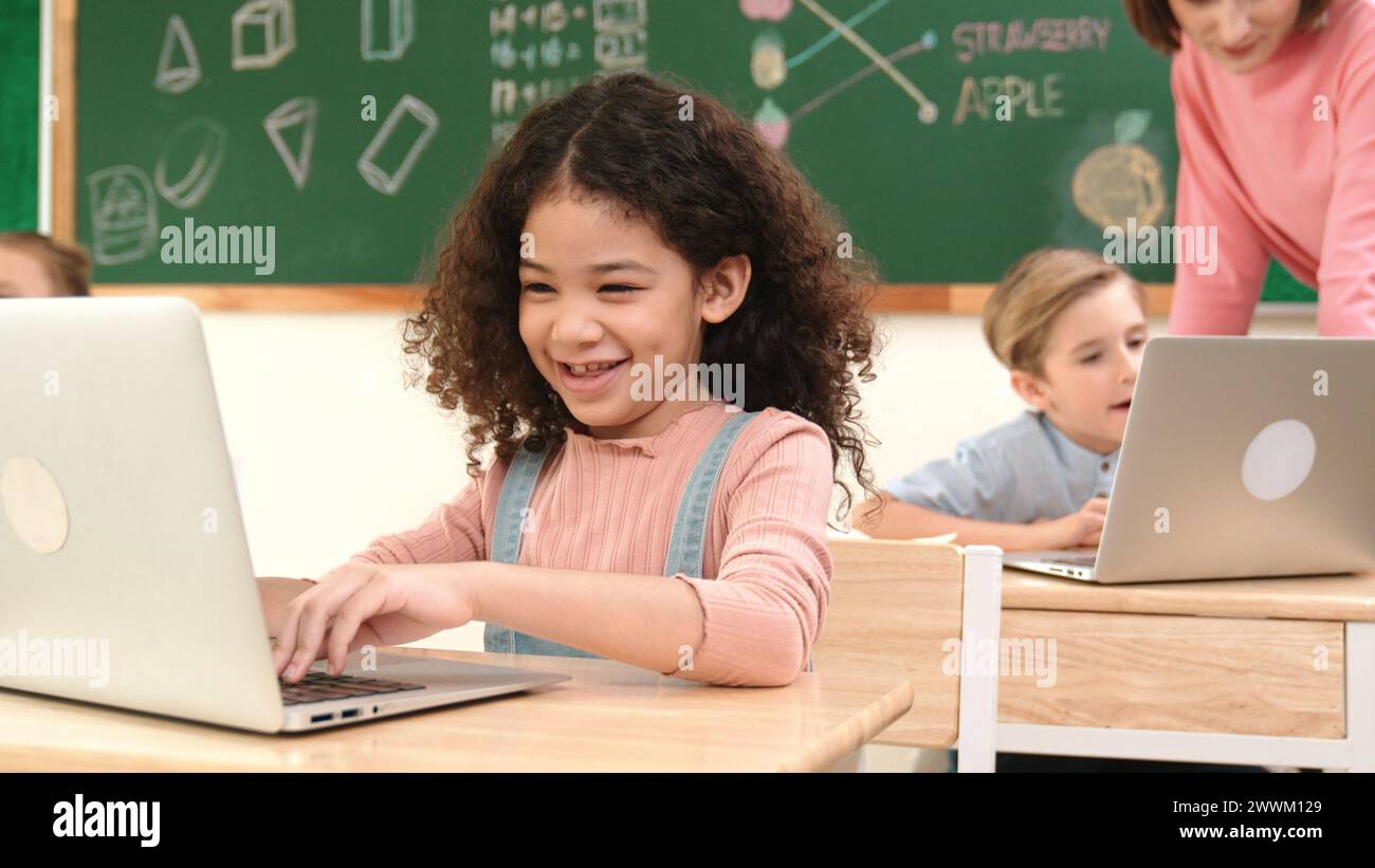 Attractive girl coding prompt while looking at camera at STEM class ...
