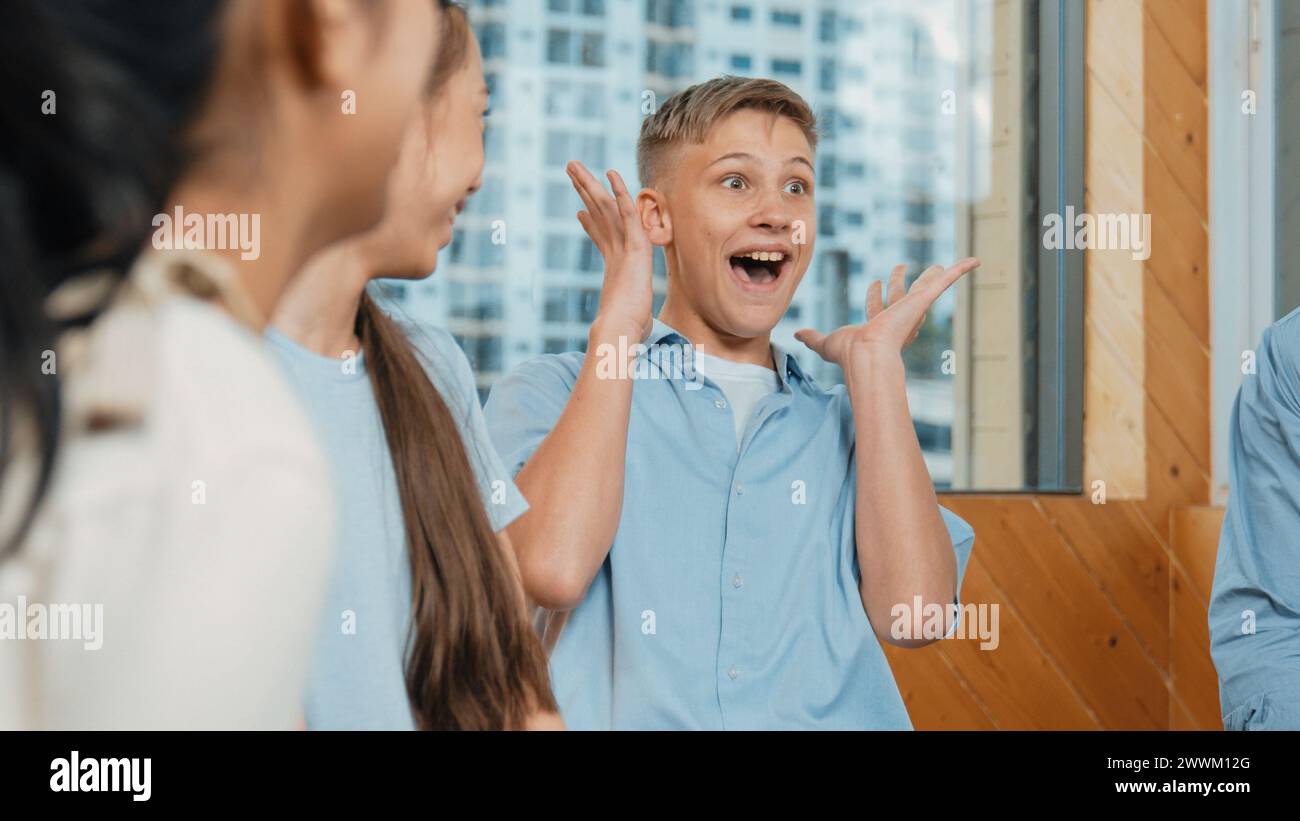 Smart happy boy making surprise face while attend discussion group with ...