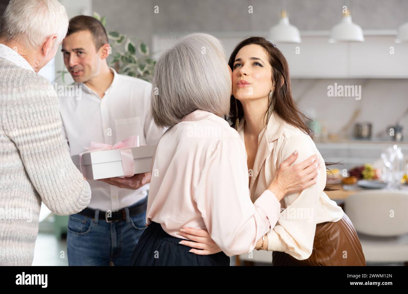 After chatting and gatherings, women friends hug and kiss goodbye Stock ...
