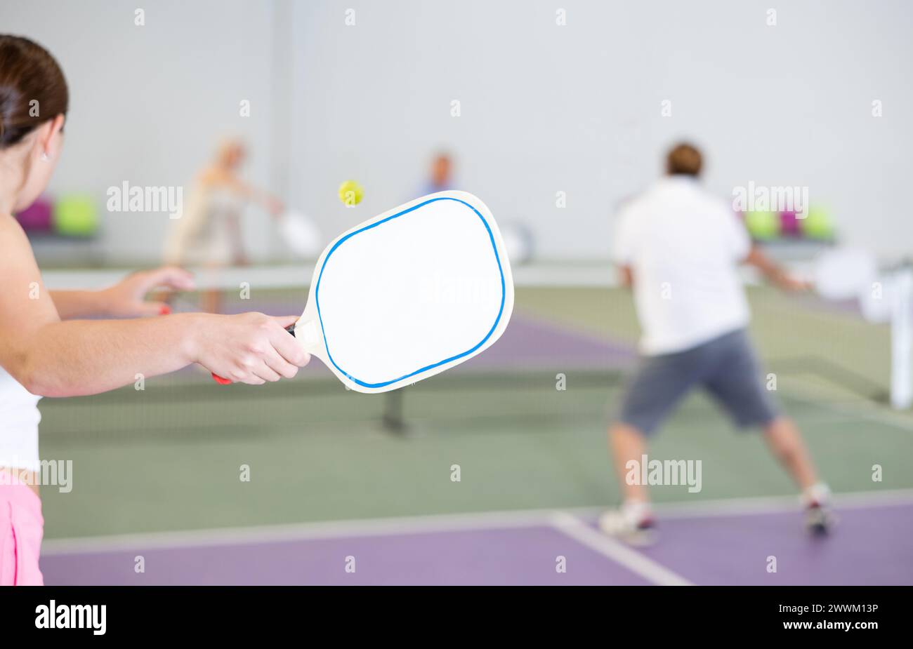 Paddle-shaped racquet for pickleball in hand of female player Stock ...