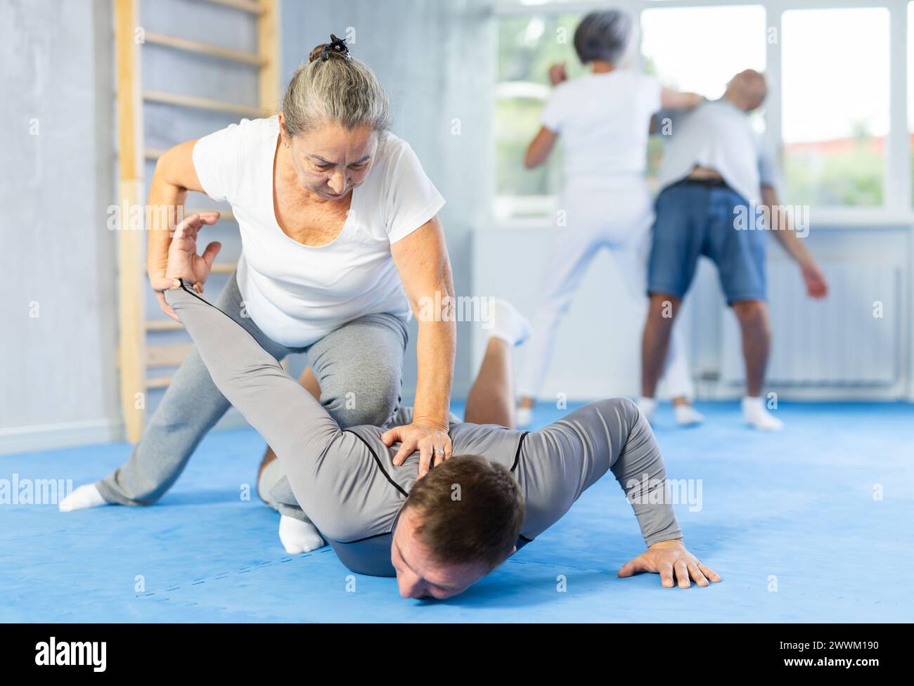 Old woman twisting her opponent's arm during self-defense classes Stock ...