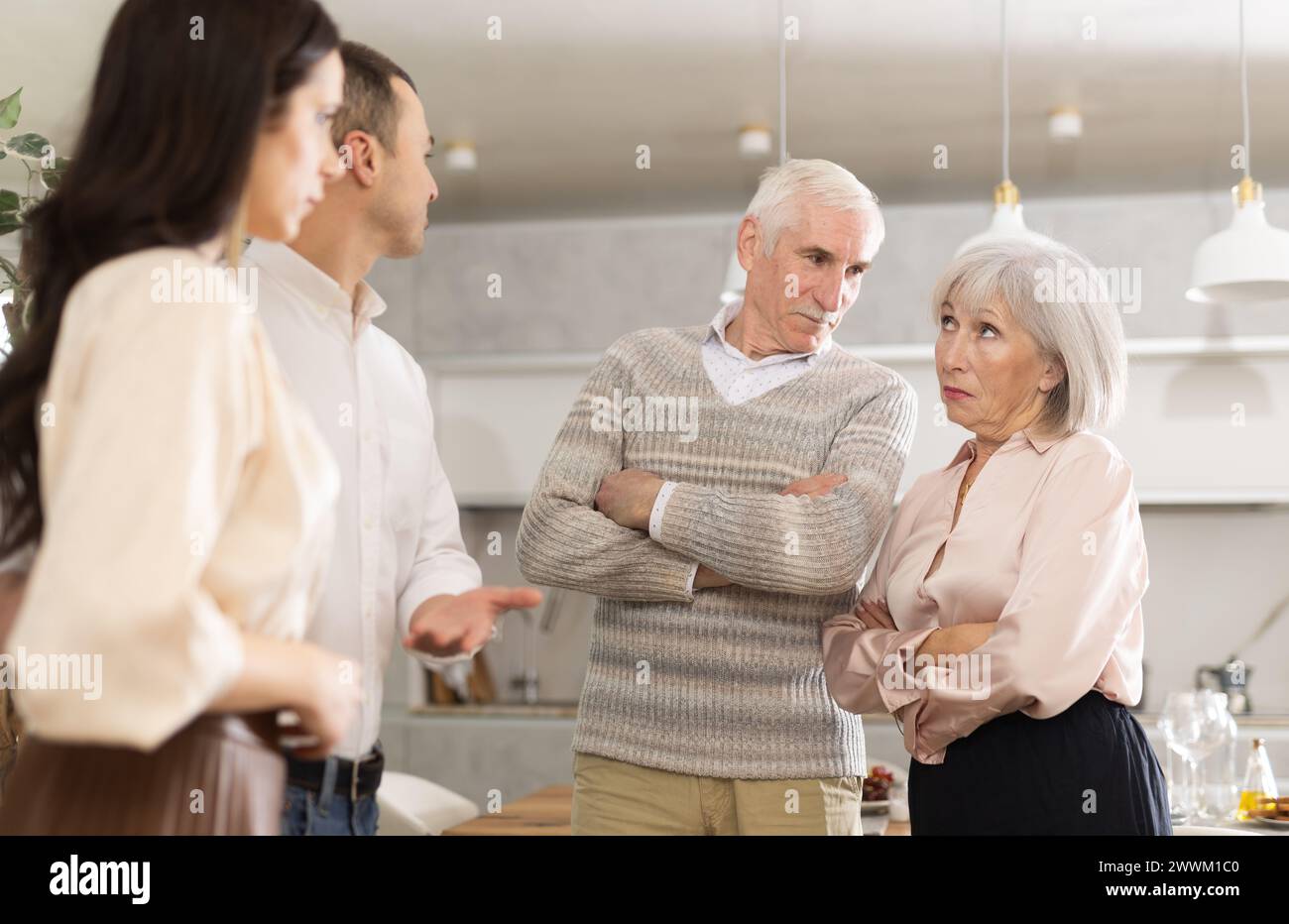 Young guy introducing his girlfriend to his discontented parents at ...