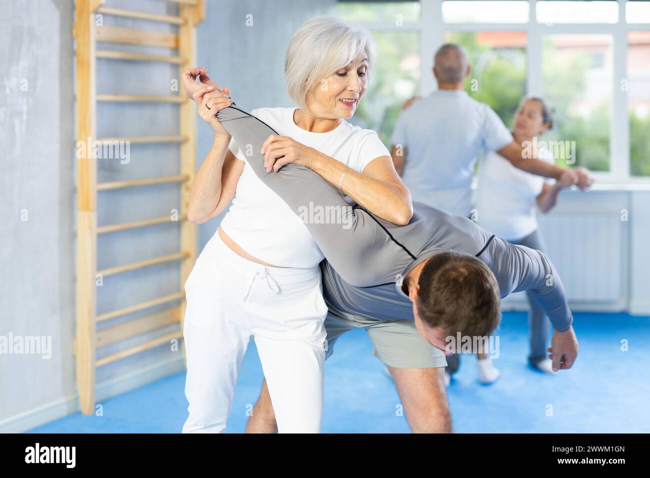 Elderly woman twists arm of attacking man with painful hold in gym ...