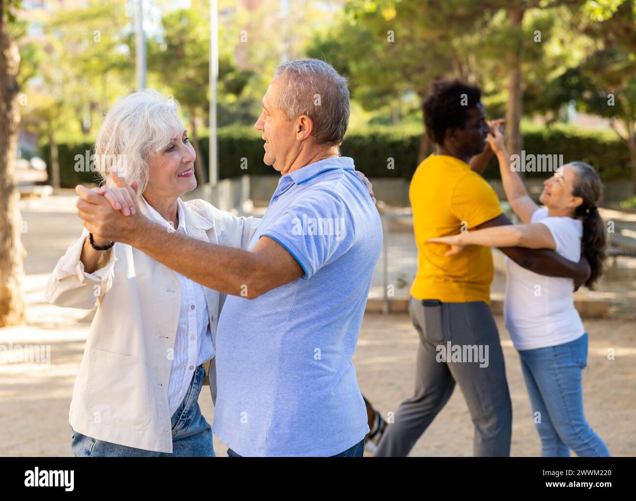 Happy positive smiling adult friends dancing pair dance in garden Stock ...