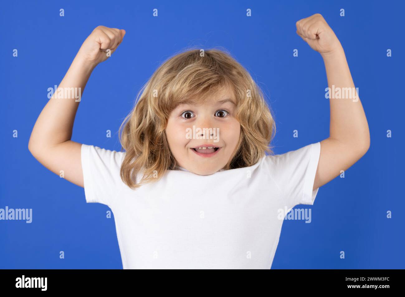 Excited kid boy celebrating victory on studio isolated background ...