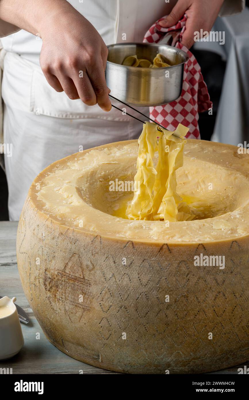 Fresh pasta with sauce in a whole parmesan wheel Stock Photo - Alamy