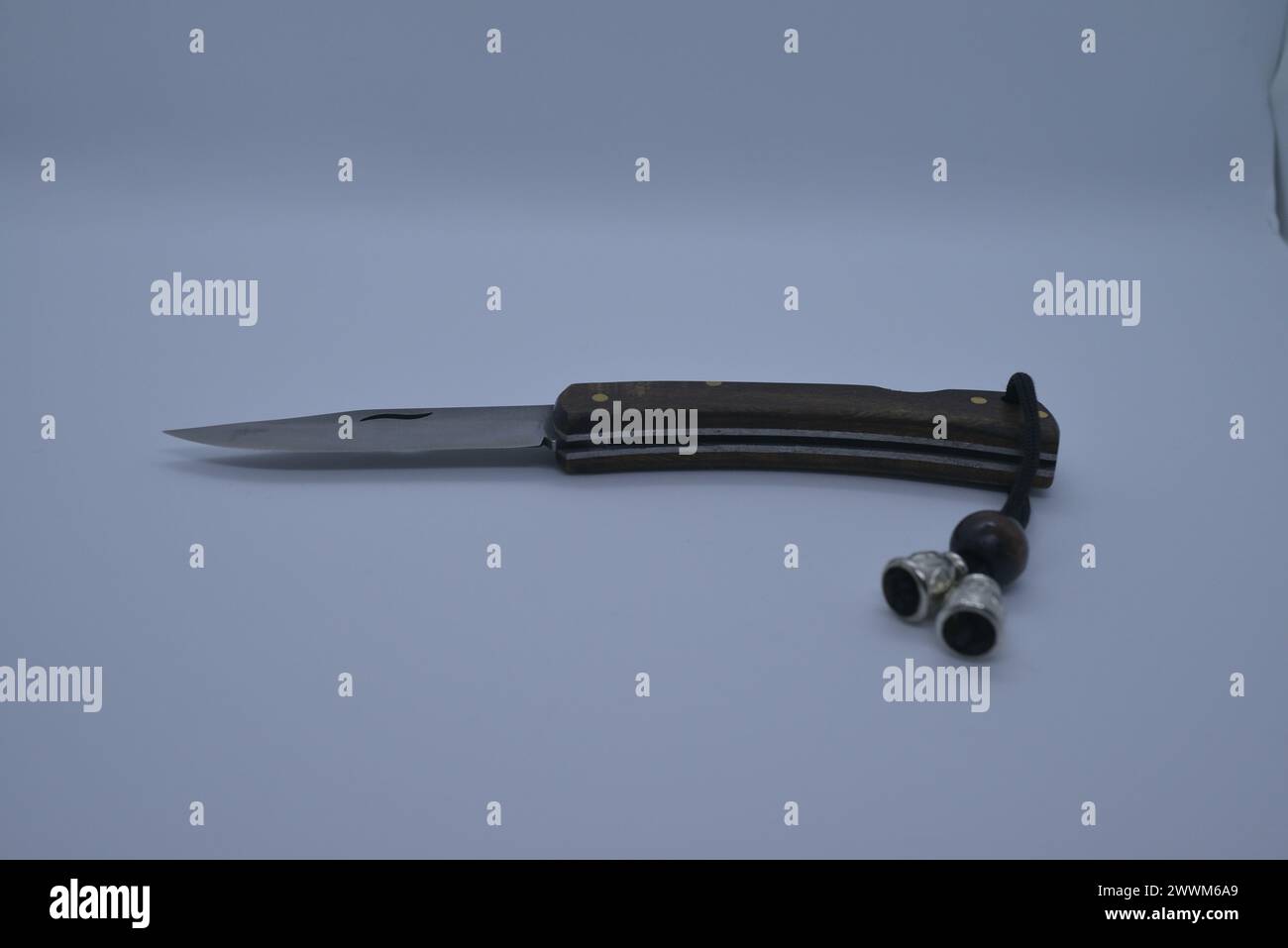 An open pocketknife displayed against a white background, revealing its ...